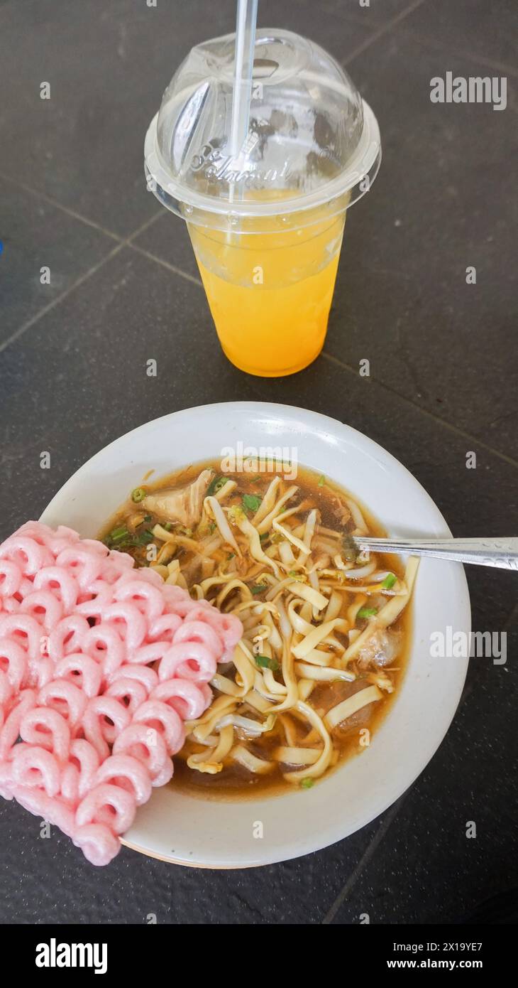 This delicious noodle soup is served with pink crackers, usually called ...