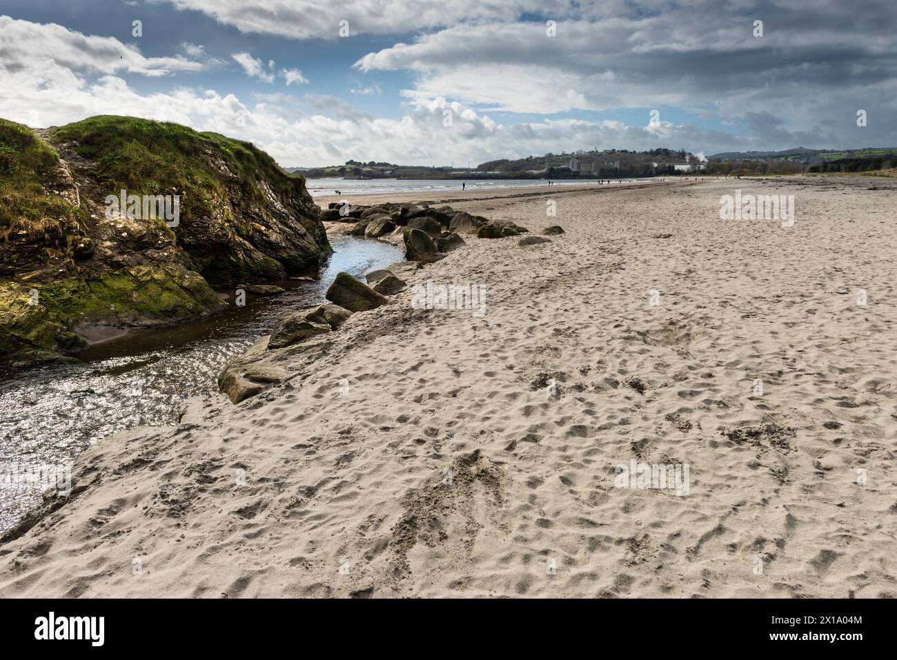 The Par Polmear River flowing towards the sea at Par Beach in Cornwall ...