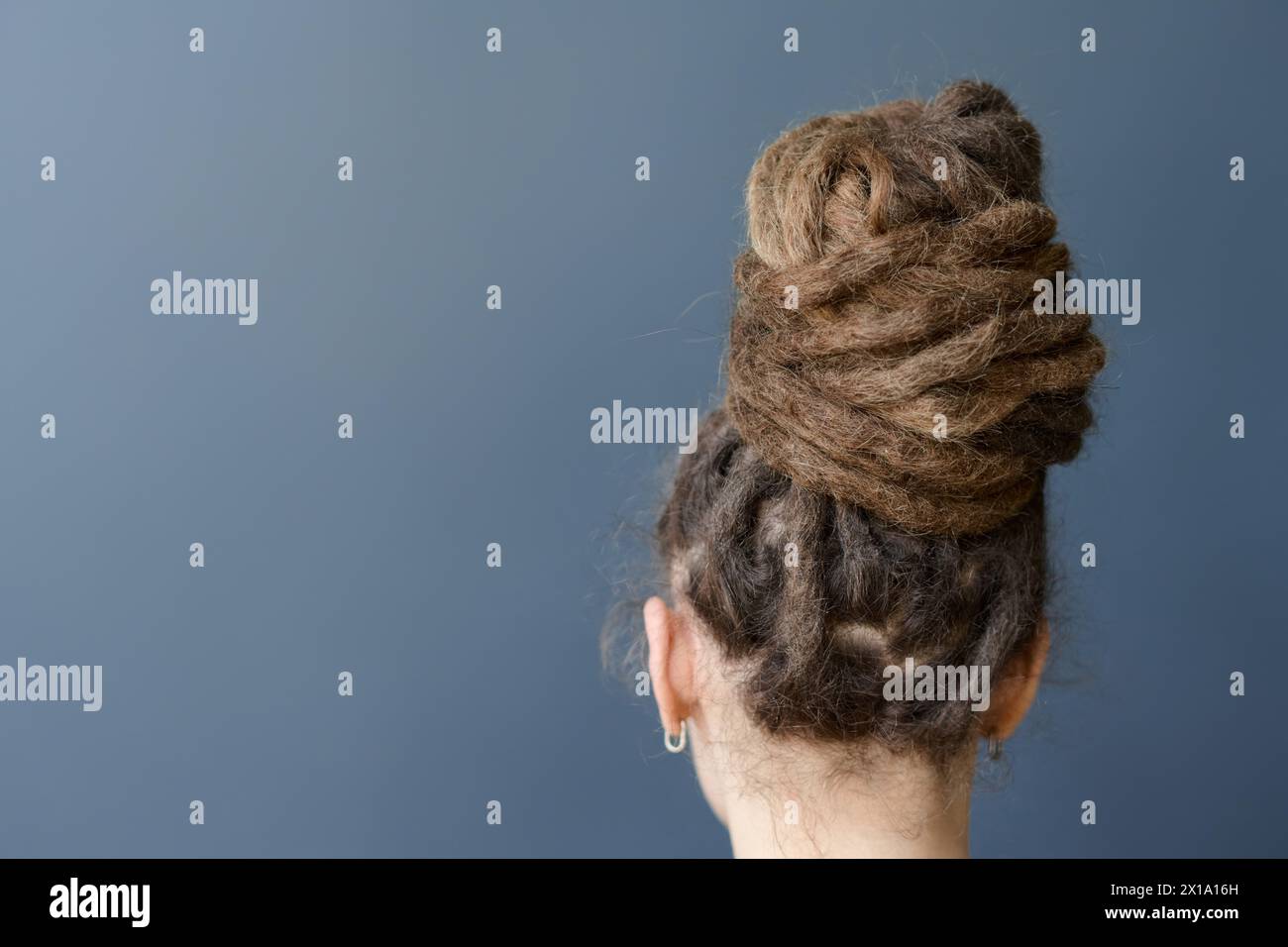 Minimal back view of unrecognizable Caucasian woman with dreadlocks in ...
