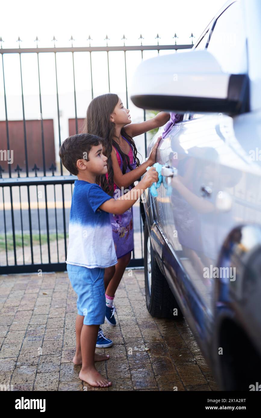 Children, car wash and helping siblings or outdoor together for to do ...