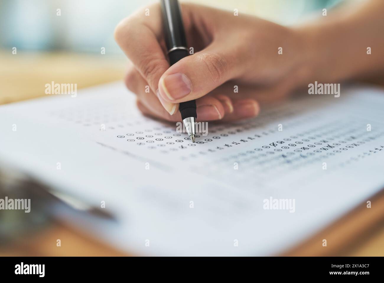 Woman, hand and writing a test with choice on clipboard for exam ...