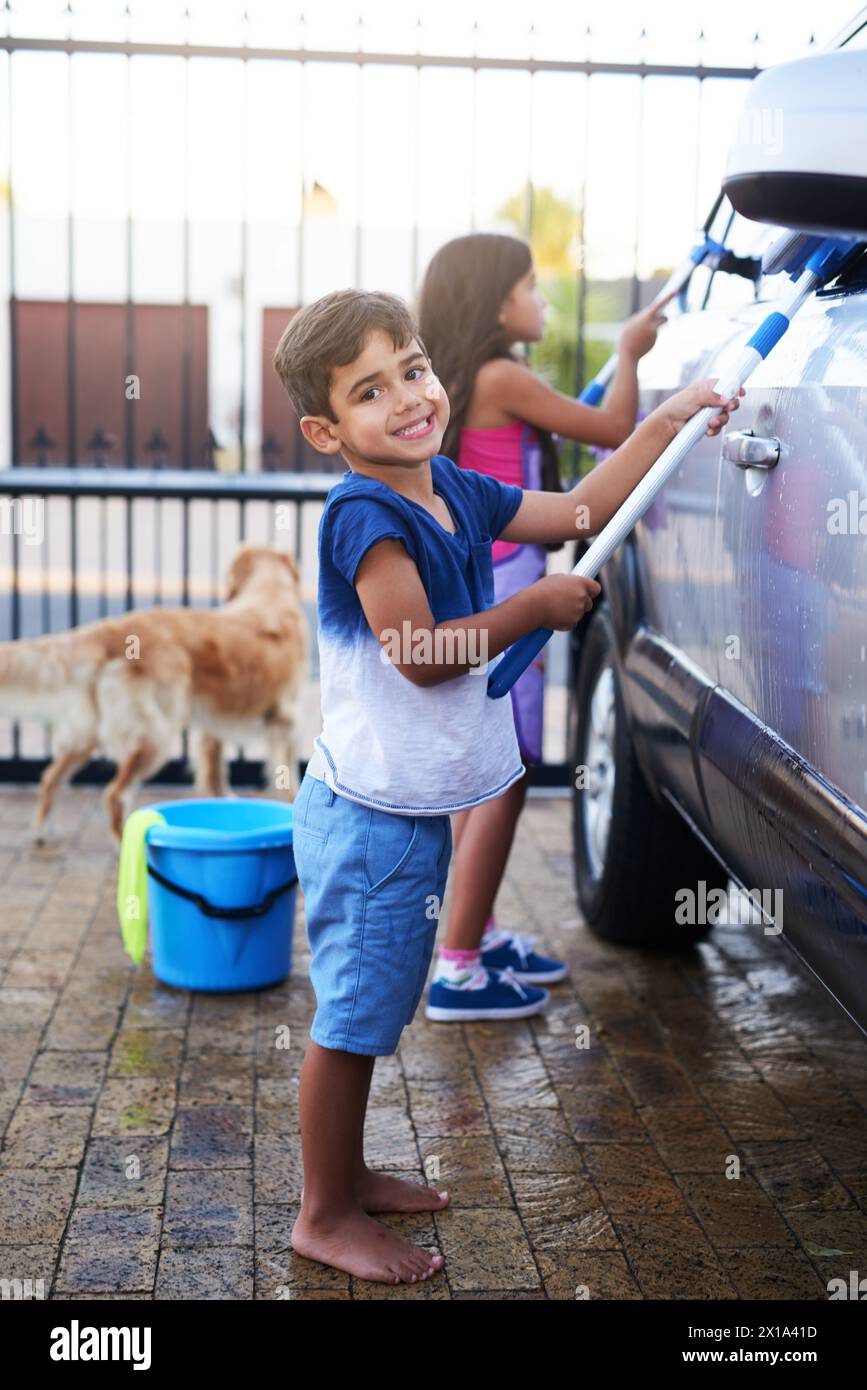 Children, fun and home and washing car, portrait kids cleaning motor ...