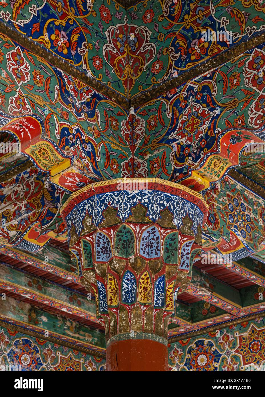 Detail view of traditional column capital and ceiling woodcarving and ...