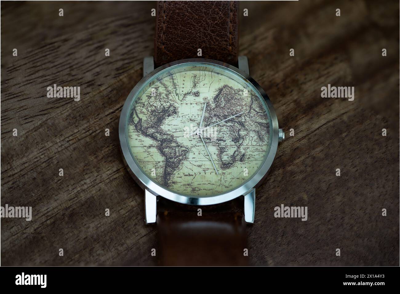Wrist watch close up with a globe dial Stock Photo - Alamy