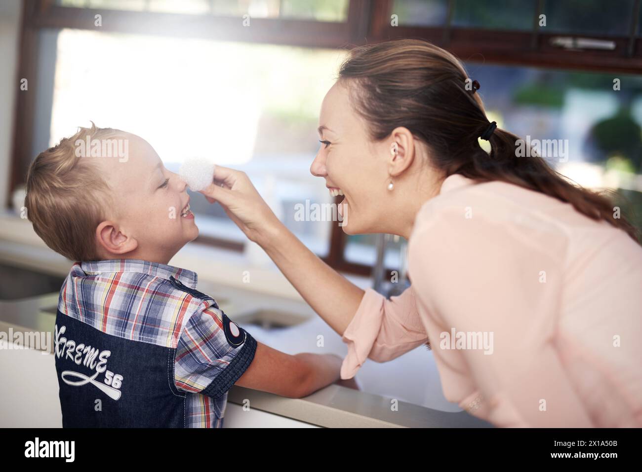 Happy, parent and child in kitchen cleaning for education, development ...