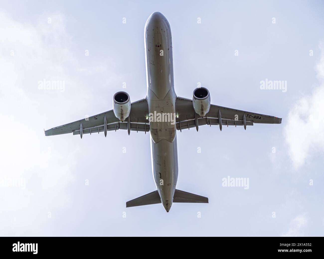 Underneath photo of a airplane taking off from an airport Stock Photo ...