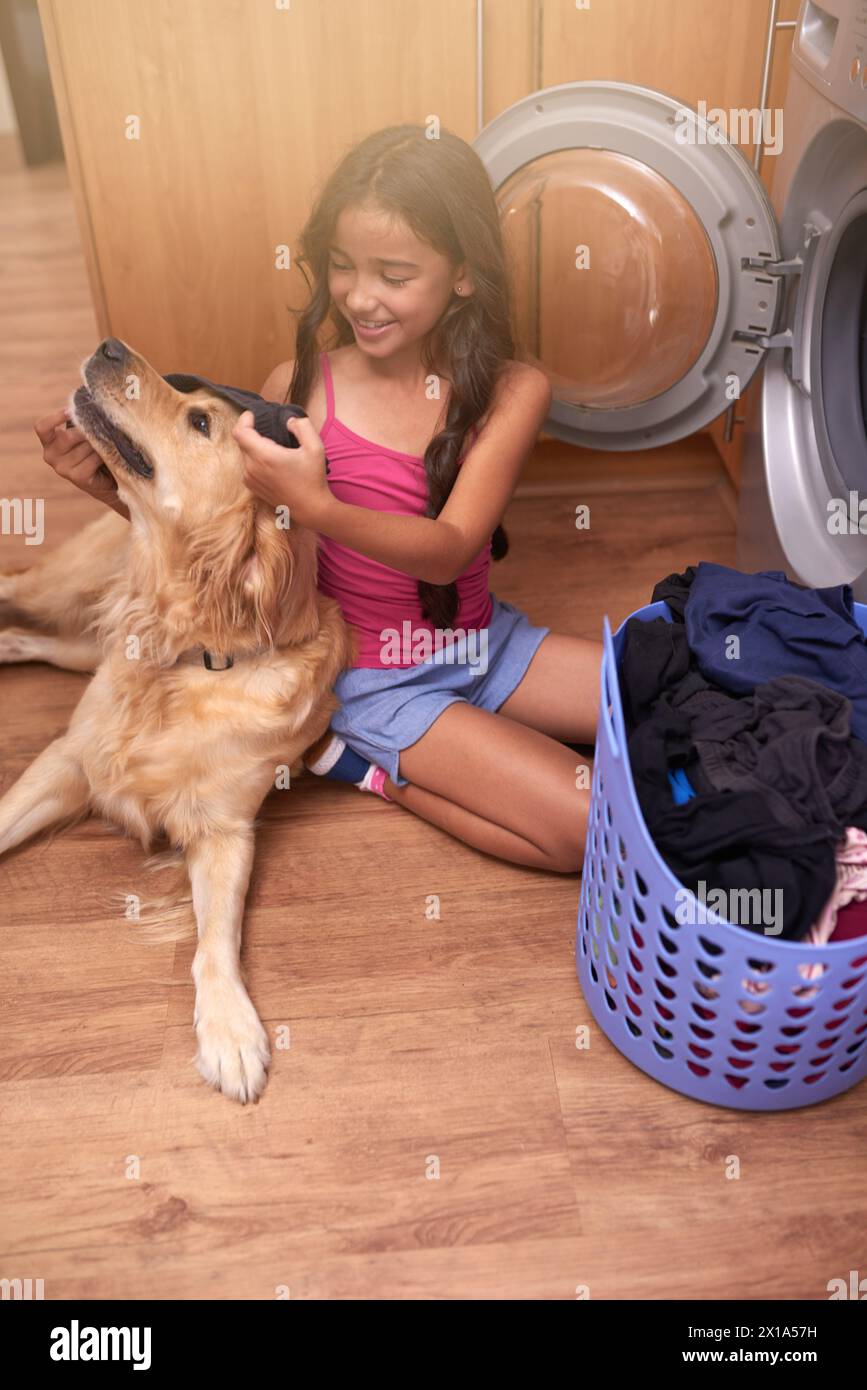 Washing machine, dog and child with laundry in home for cleaning ...