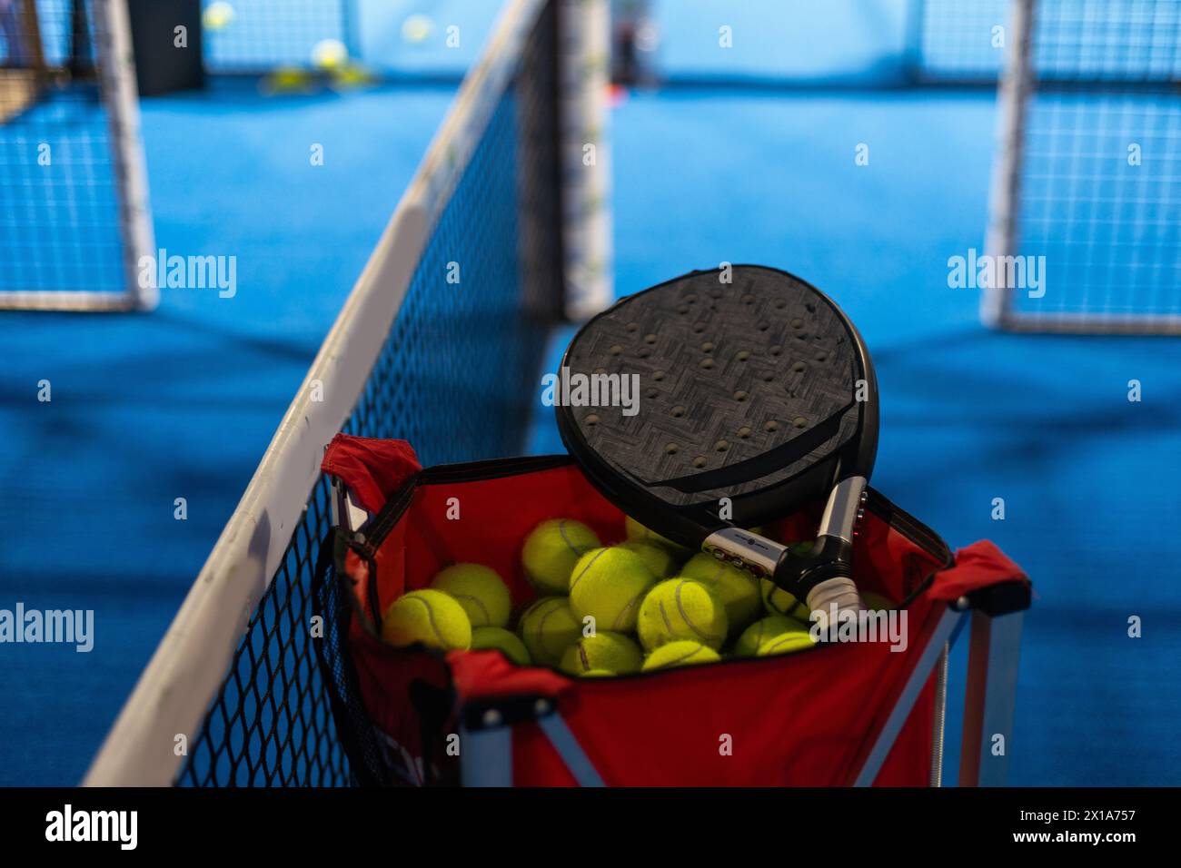 Paddle tennis rackets, balls and basket in court still life Stock Photo ...
