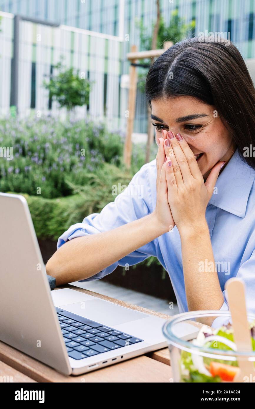 Overjoyed businesswoman reading unexpected message on laptop computer ...