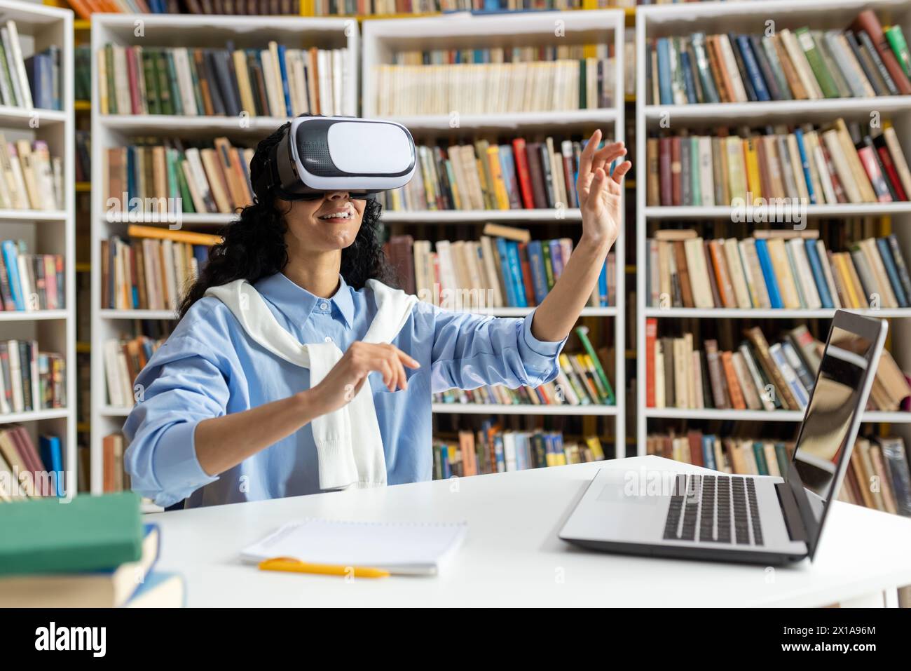 A young woman engages with a virtual reality headset, exploring digital ...
