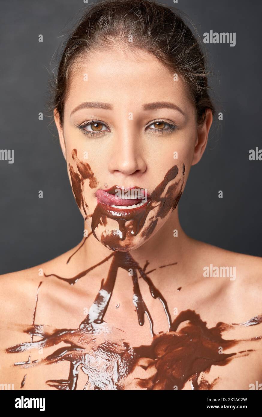 Woman, licking lips and chocolate on body for temptation, sweet craving ...