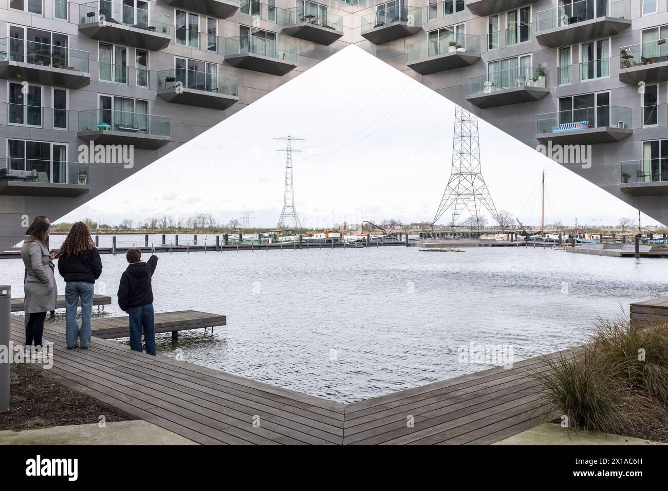 People look out from the jetty in courtyard of the Sluishuis condos in ...