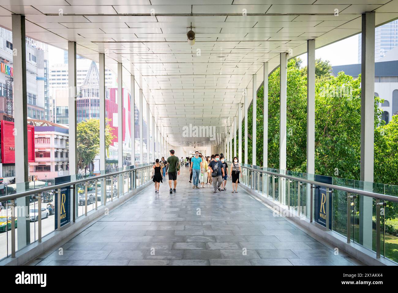 Pedestrians make their way along Ratchaprasong Sky Walk, above ...