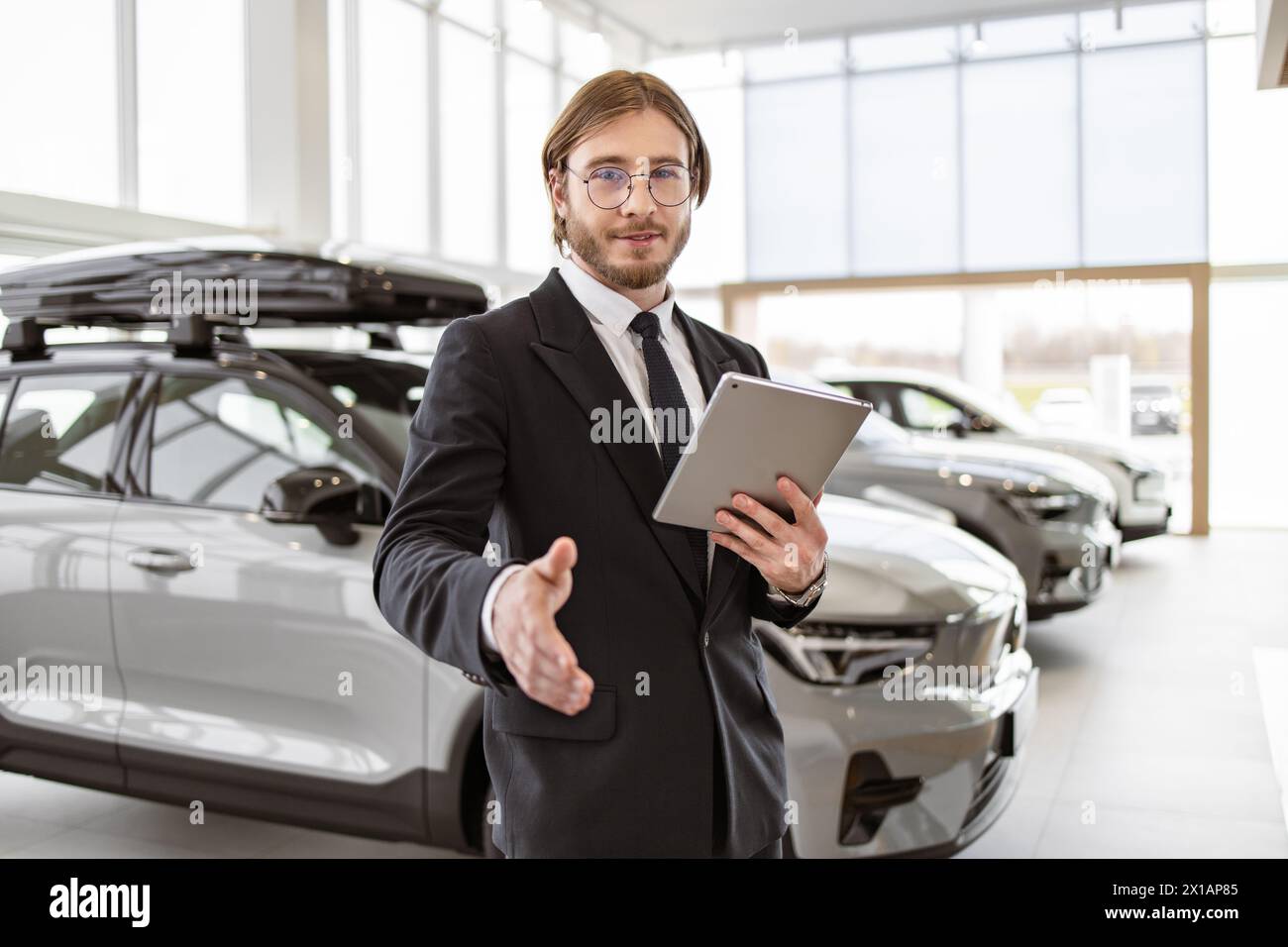 Successful bearded manager shaking hand with buyer on background of ...