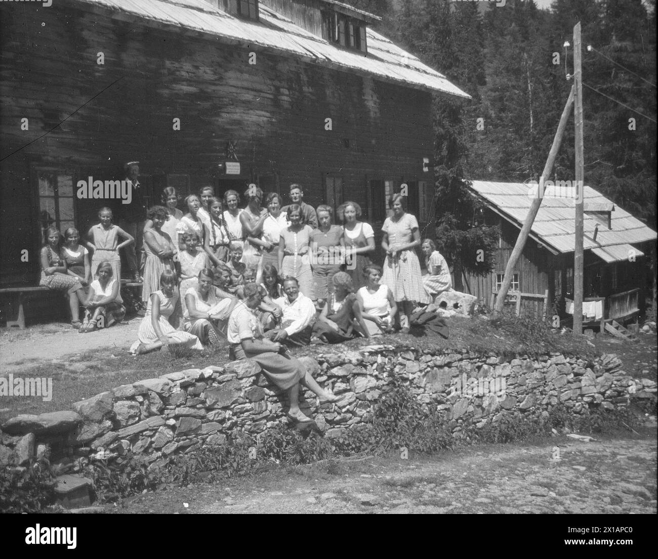Group in front of huts hi-res stock photography and images - Alamy
