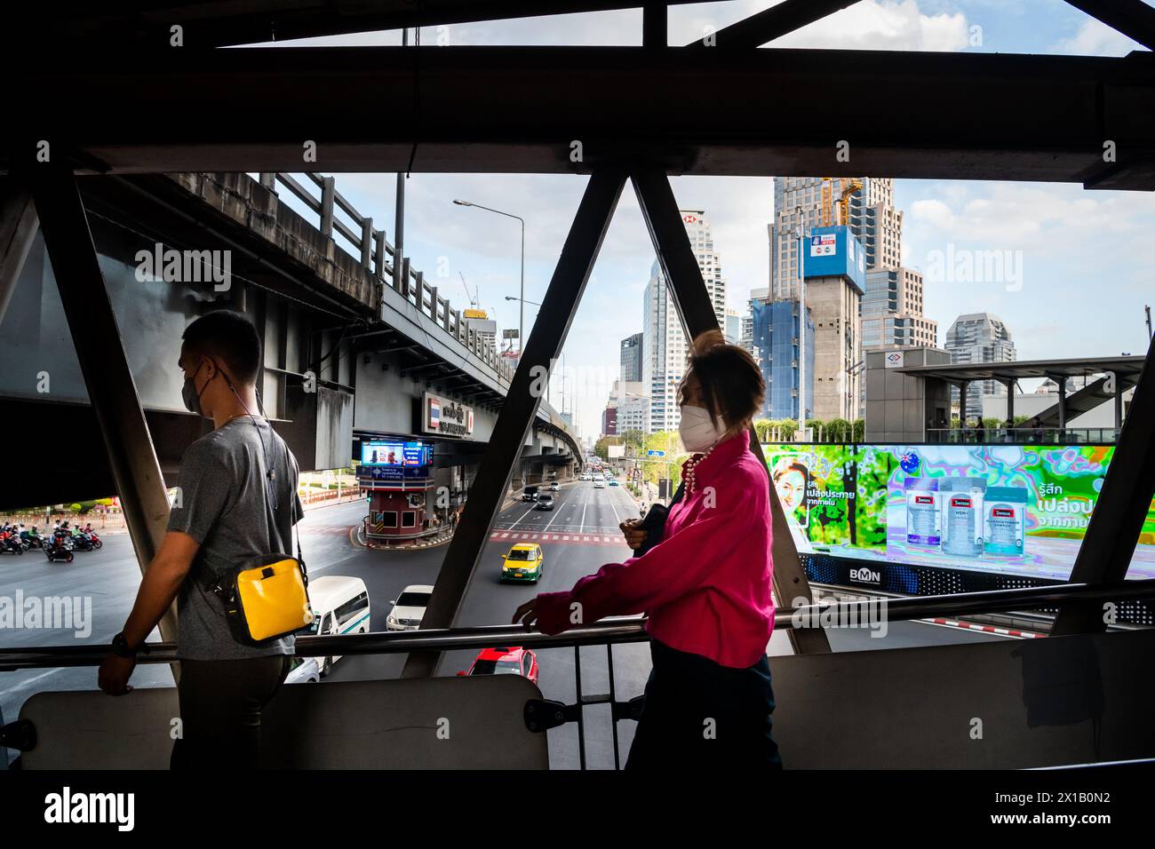 Pedestrians walking along a sky walk towards the Sala Daeng BTS skytrain station in the Silom ...