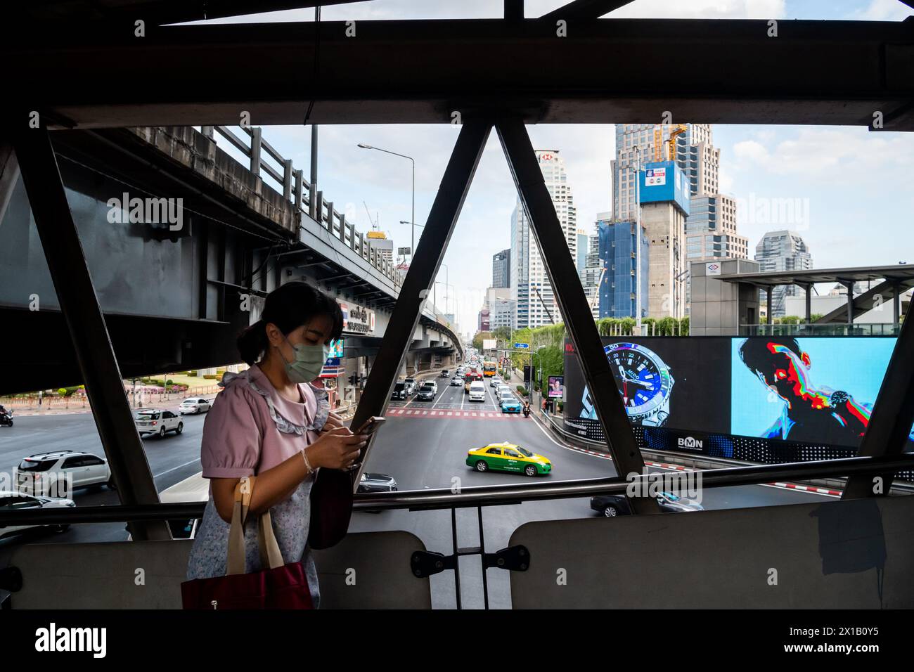 Pedestrians walking along a sky walk towards the Sala Daeng BTS skytrain station in the Silom ...