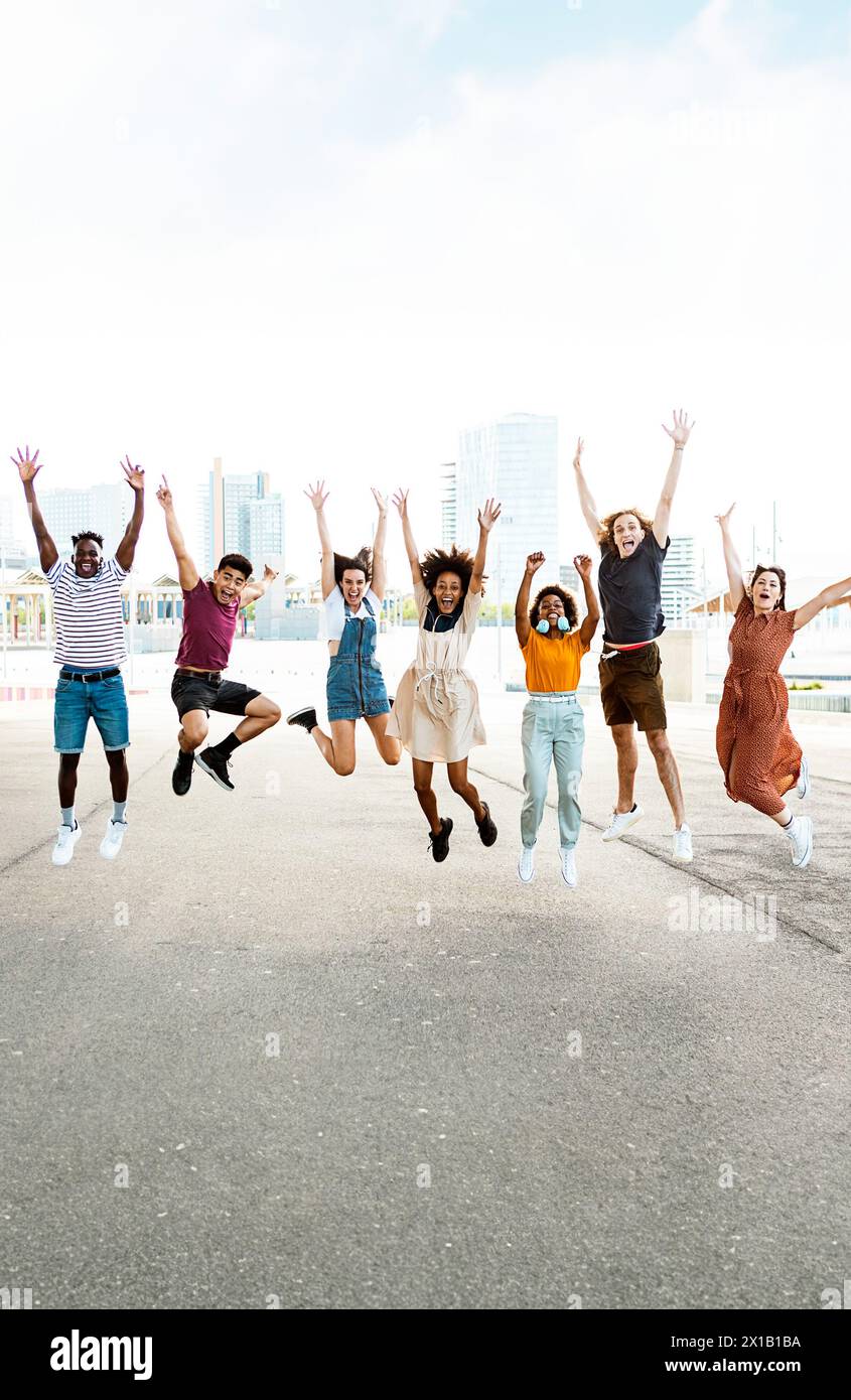 Happy multiracial people jumping together outdoors Stock Photo - Alamy