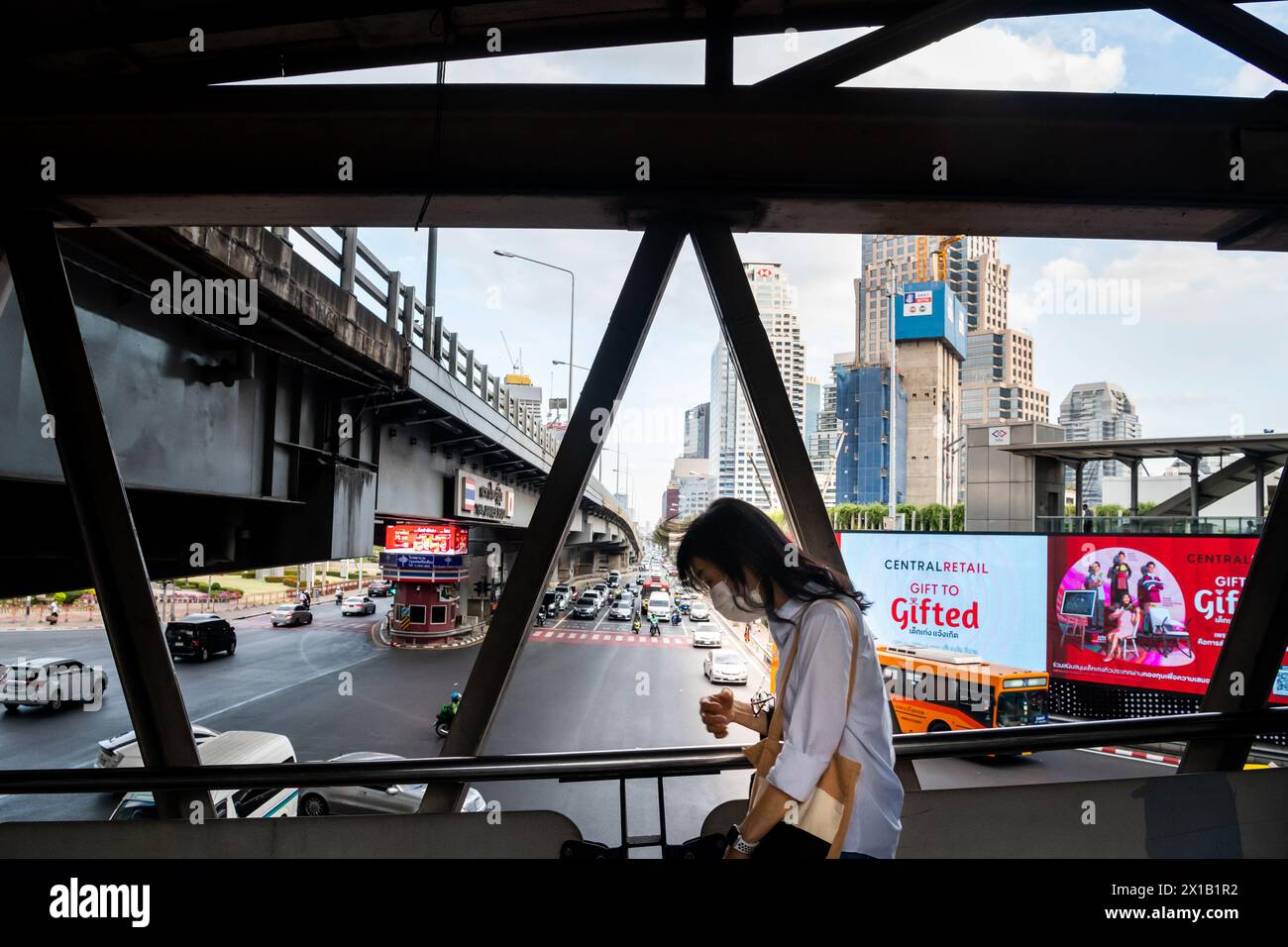 Pedestrians walking along a sky walk towards the Sala Daeng BTS skytrain station in the Silom ...