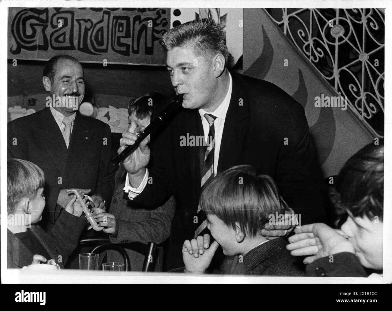 Fatty George at a children snack for orphan, George playing on a flute ...