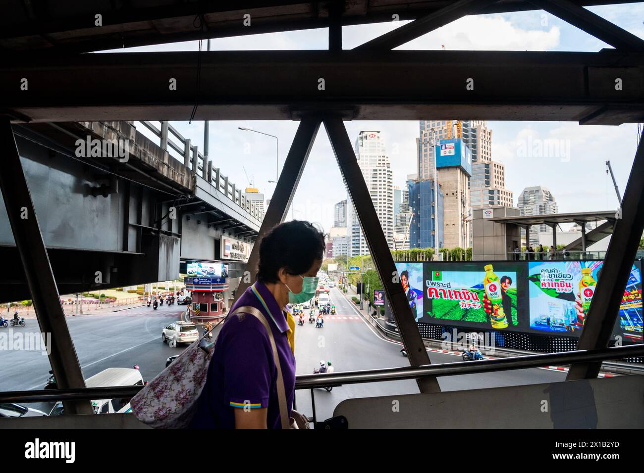 Pedestrians walking along a sky walk towards the Sala Daeng BTS ...