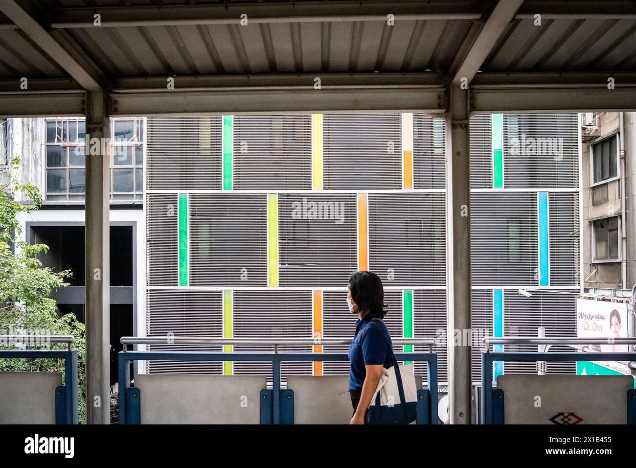 Pedestrians walking along a sky walk at Sala Daeng BTS skytrain station ...
