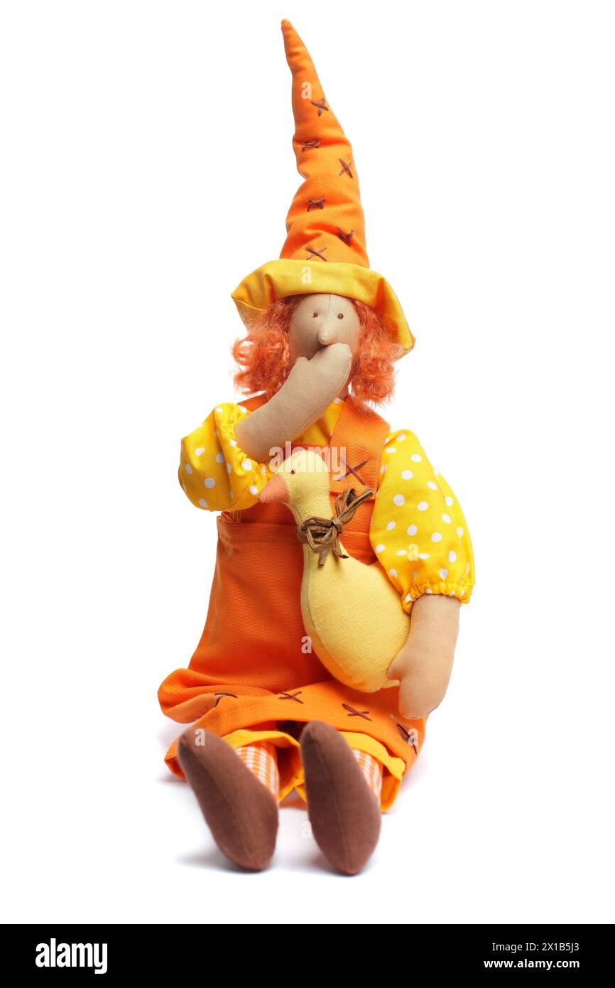 Orange color doll boy holding goose and yawning on white background ...