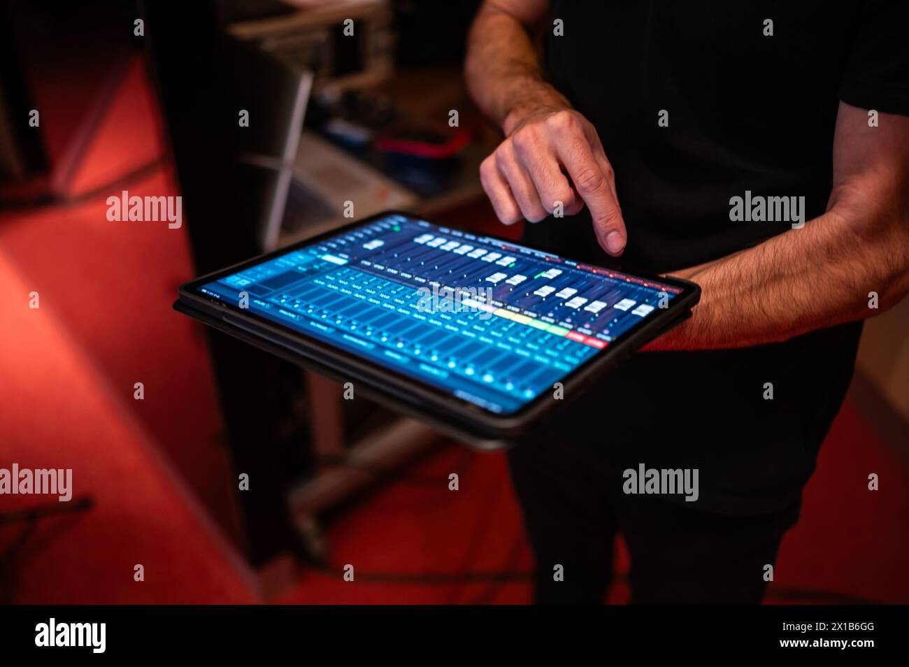 Sound engineer controlling the table from a tablet during Coffee ...