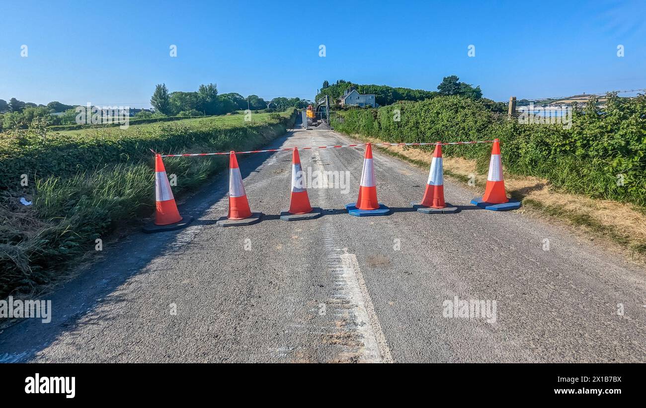 Traffic cones block a rural road while roadworks are completed Stock ...