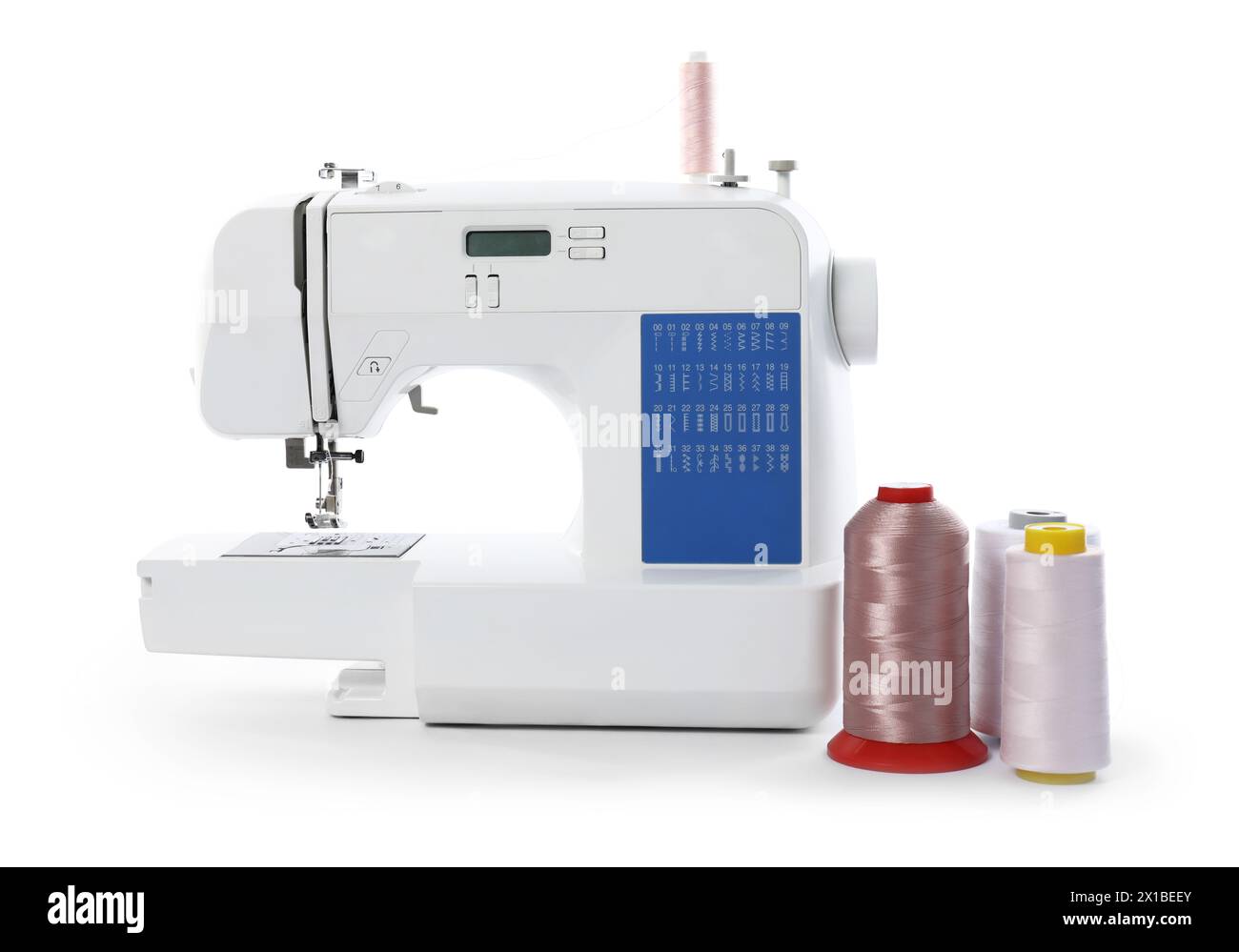 Sewing machine and spools of threads isolated on white Stock Photo - Alamy