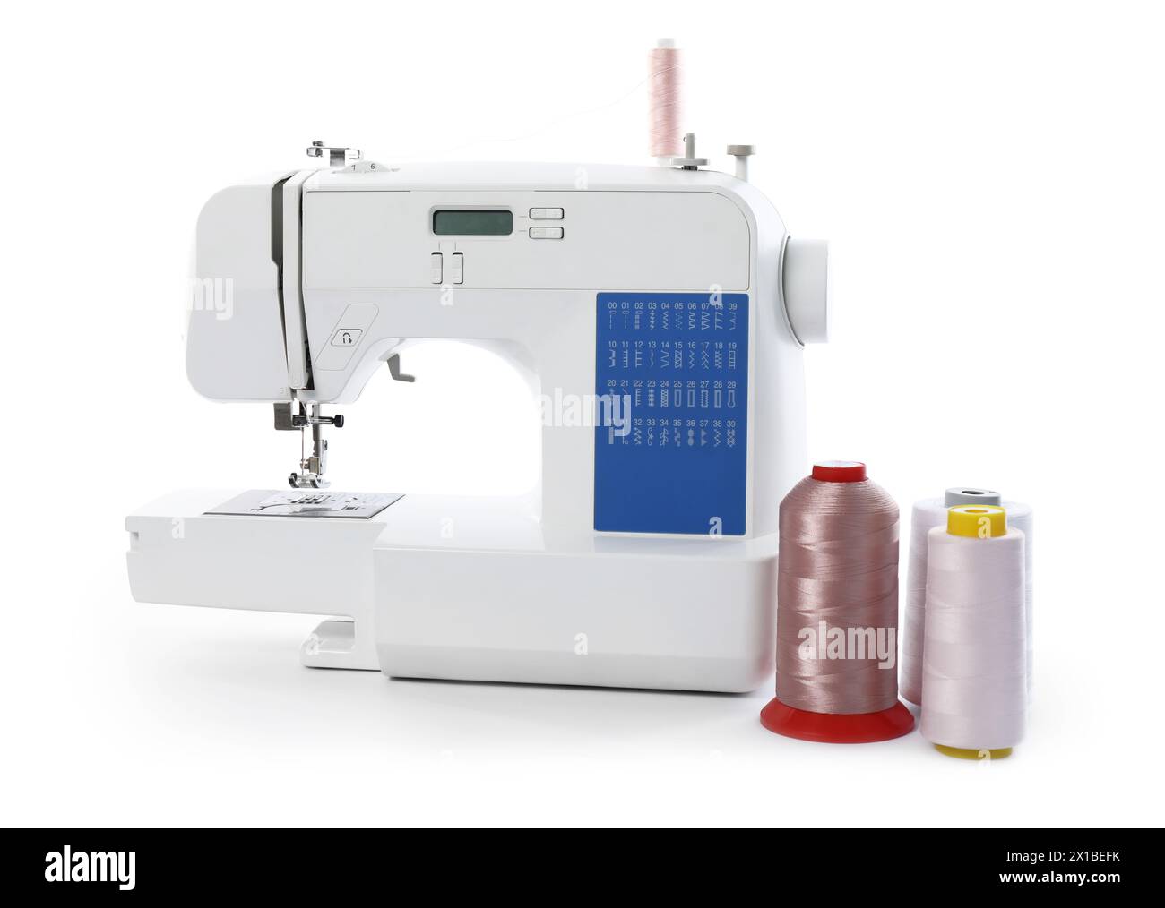 Sewing machine and spools of threads isolated on white Stock Photo - Alamy