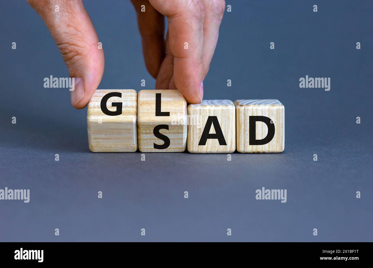 Glad or sad symbol. Businessman turns beautiful wooden cubes and ...
