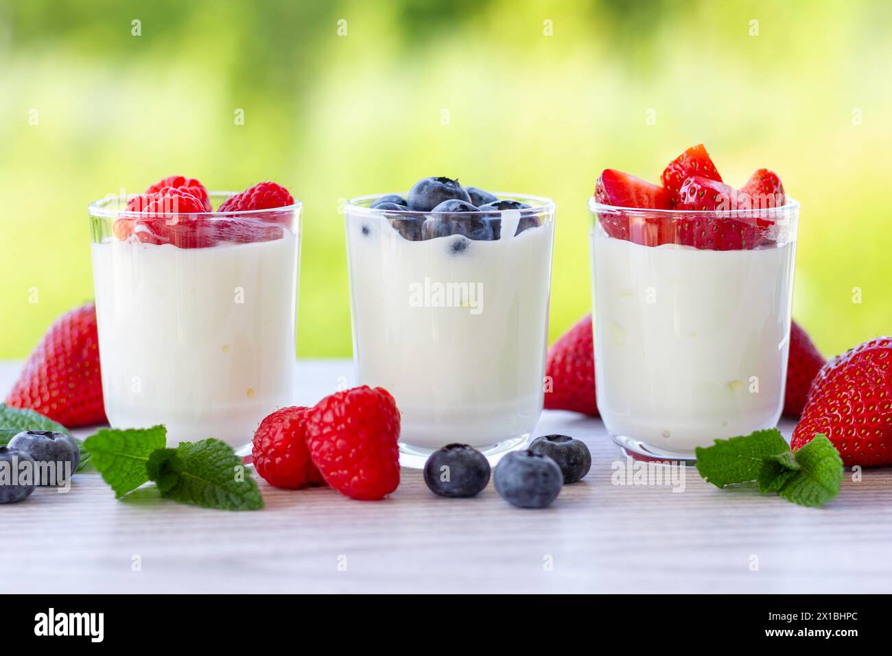 3 mini fruity yoghurt pots outdoors Stock Photo - Alamy