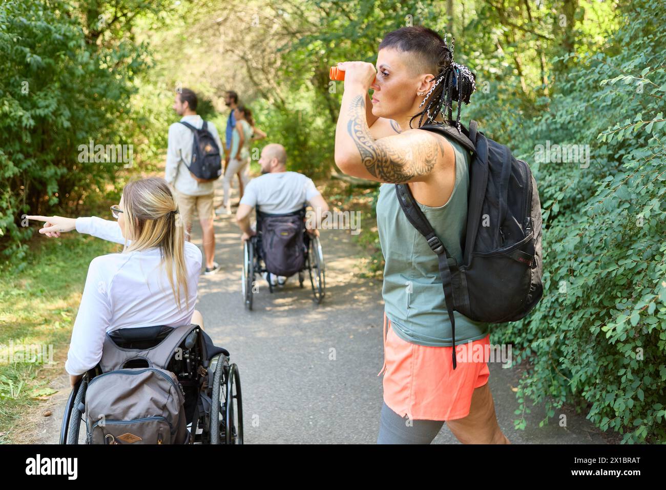 A diverse group of friends on a sunny day in the park, including ...