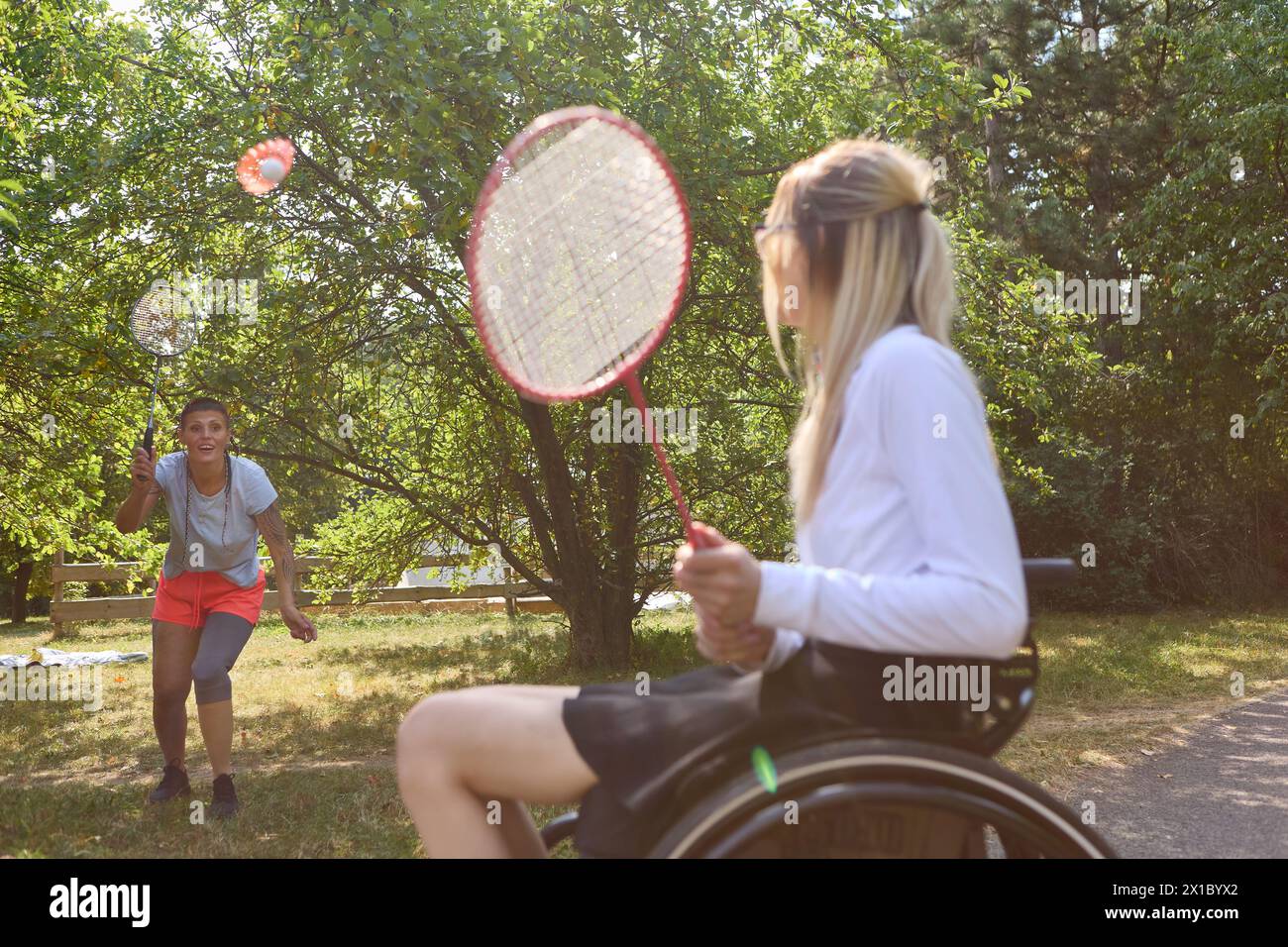 Inclusive outdoor activity with a person using a wheelchair and friend ...