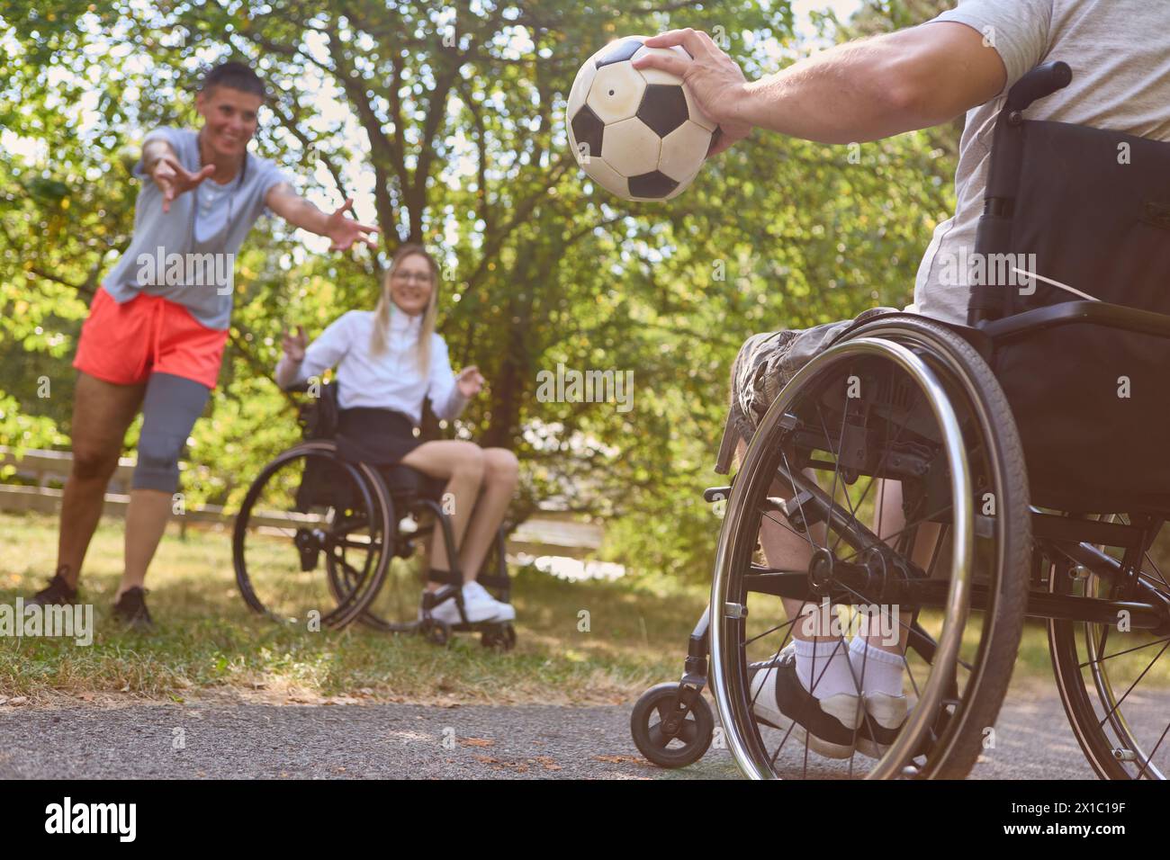 Three friends share laughter and fun in a park setting; one person who ...