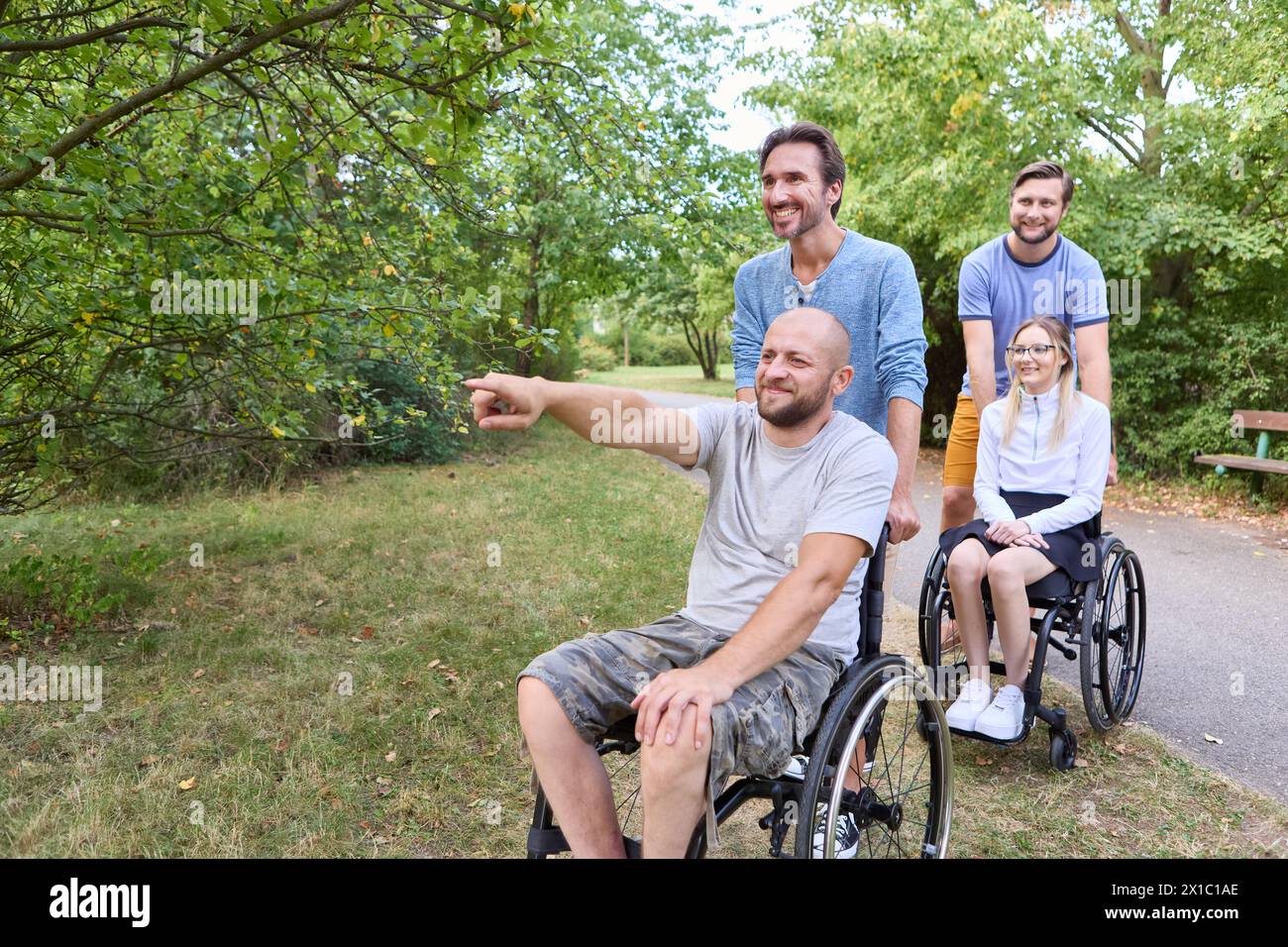 A diverse and joyful group of people, including persons in wheelchairs ...