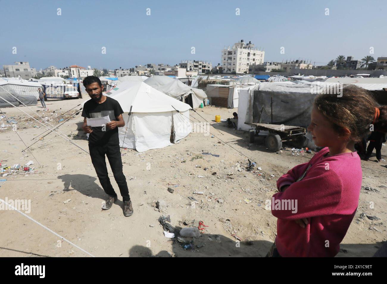 A man reads one of the leaflets dropped by the Israeli army with text ...