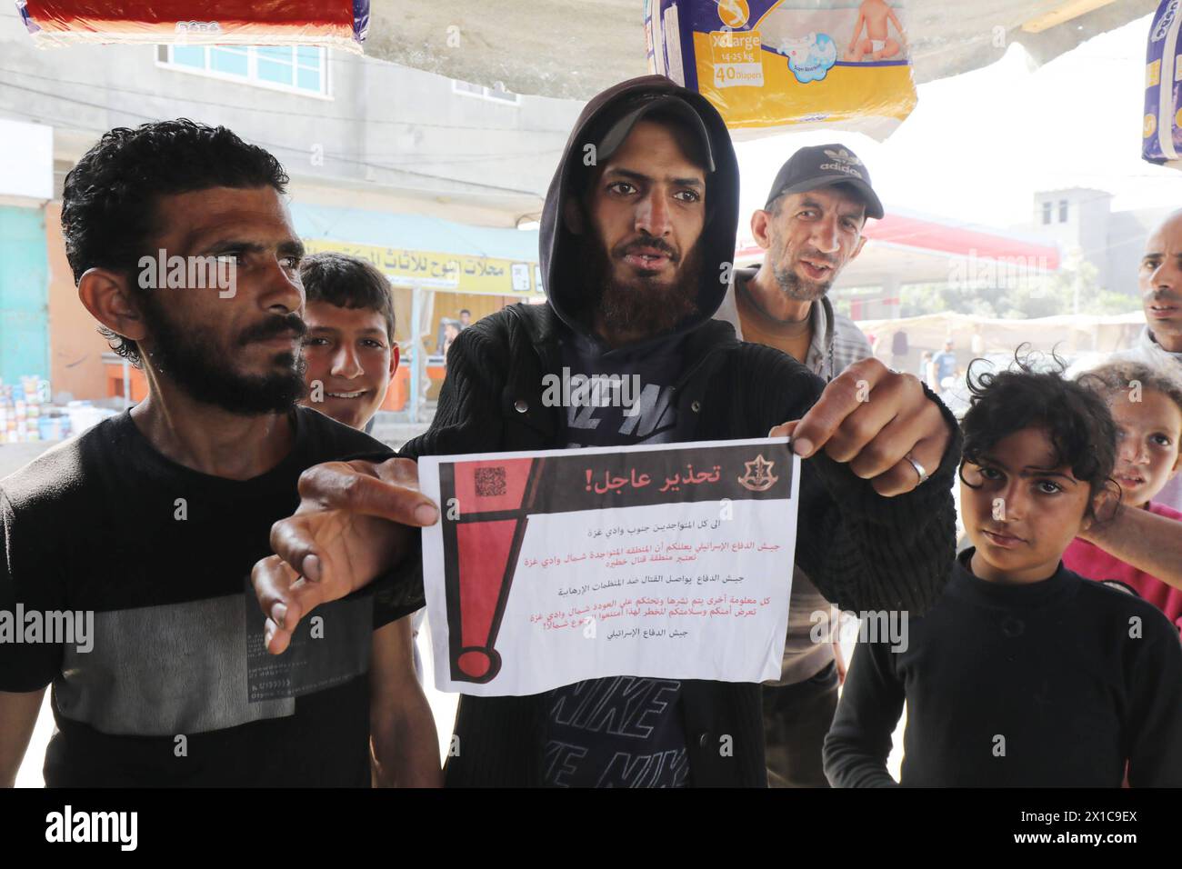 A man reads one of the leaflets dropped by the Israeli army with text ...