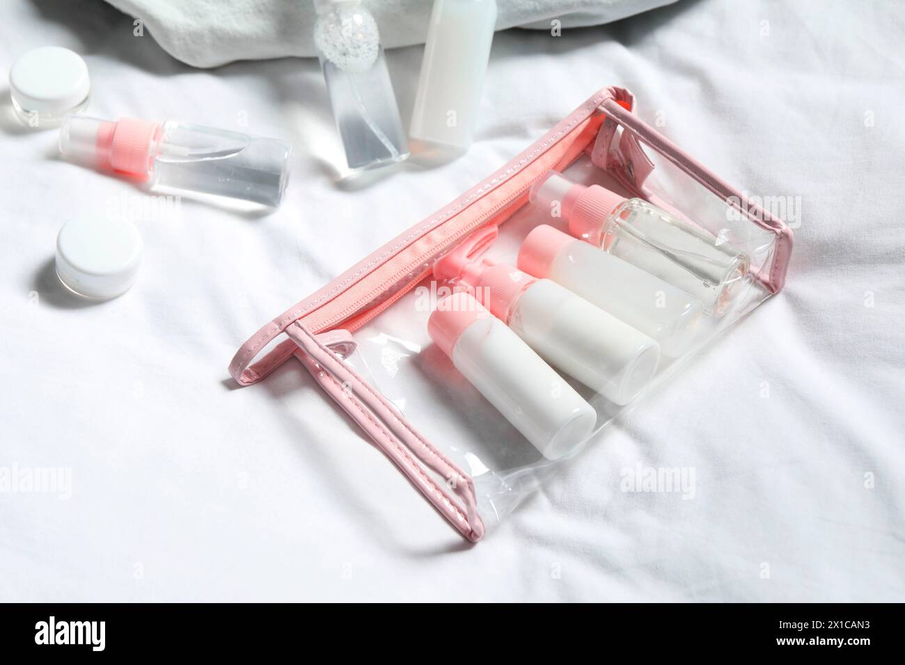 Cosmetic travel kit. Plastic bag with small containers of personal care ...