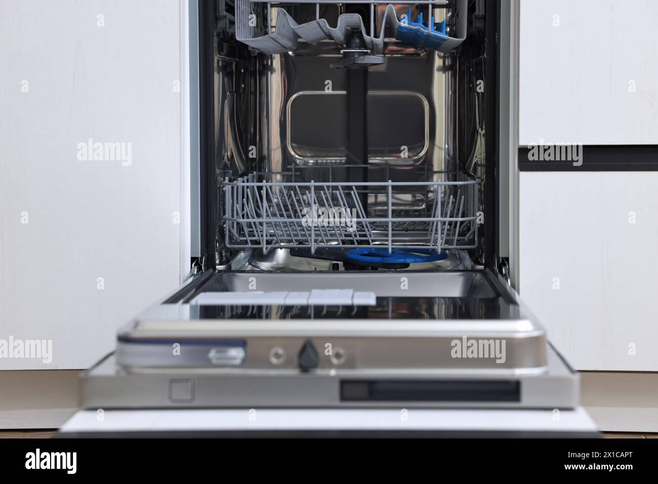 Open clean empty dishwasher in kitchen. Home appliance Stock Photo - Alamy
