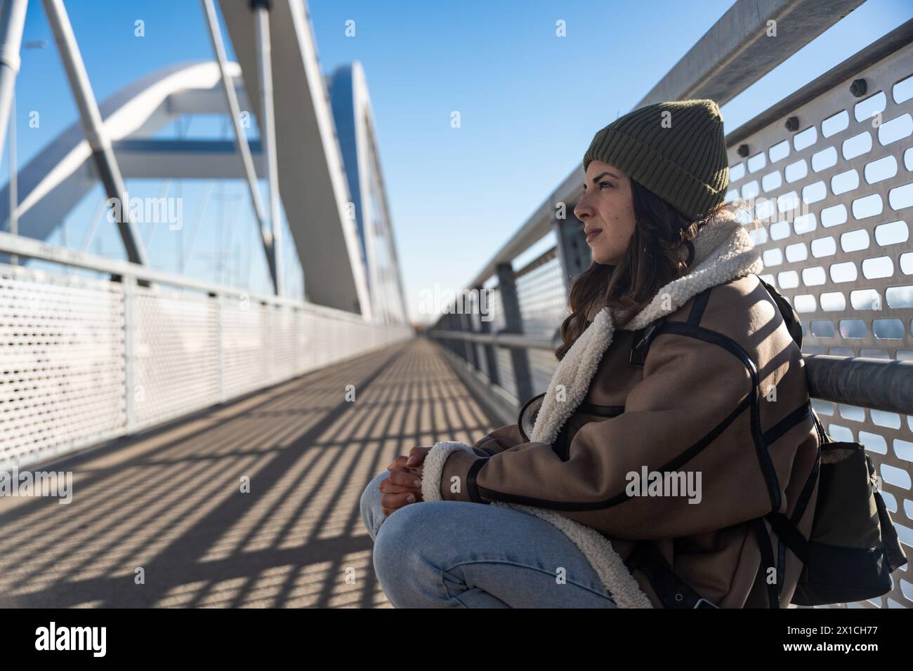 Young fashionable woman in ghetto urban street style wardrobe on the ...