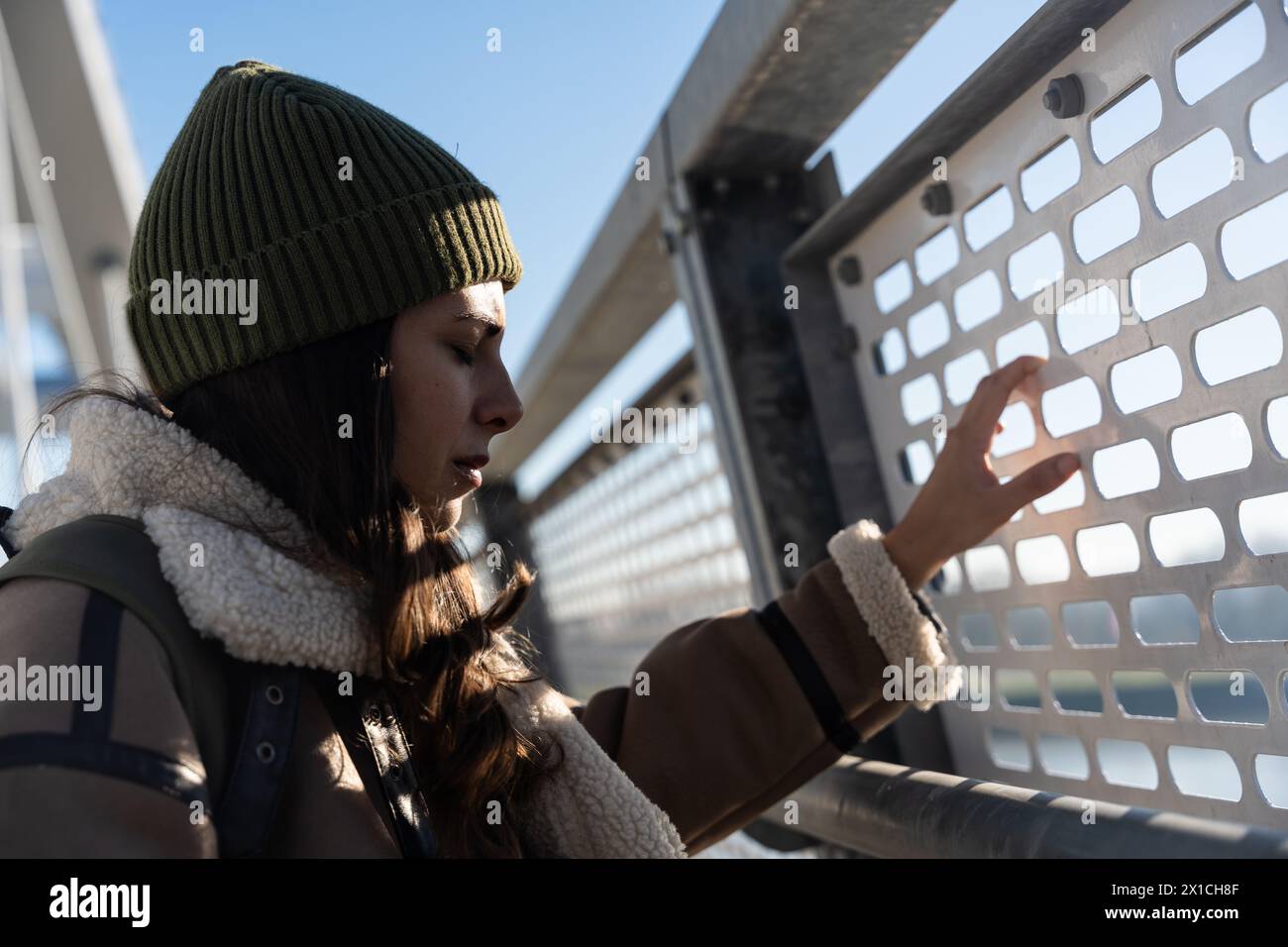 Young fashionable woman in ghetto urban street style wardrobe on the ...