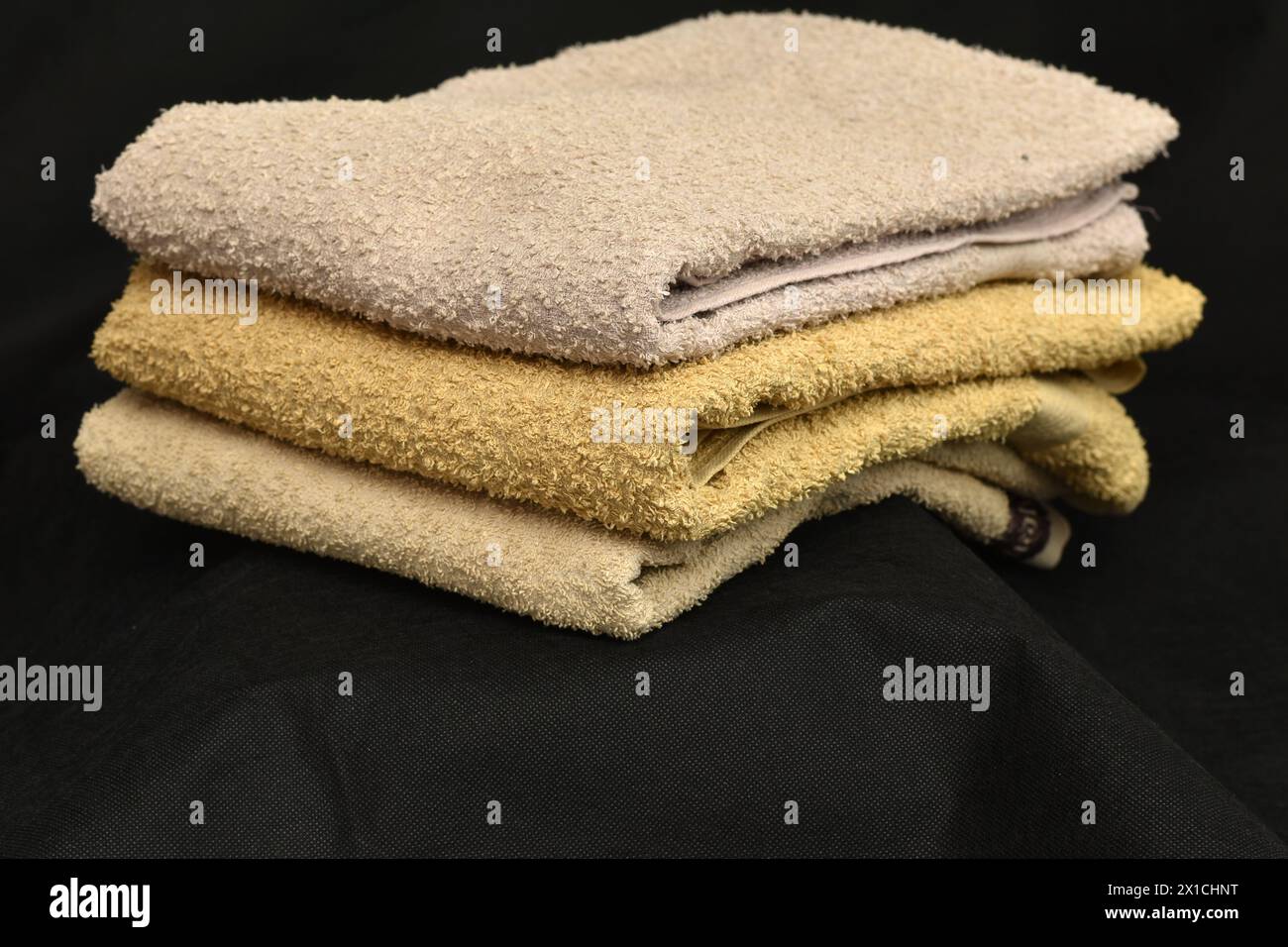 On a dark background, terry towels for the body are removed, which lie ...