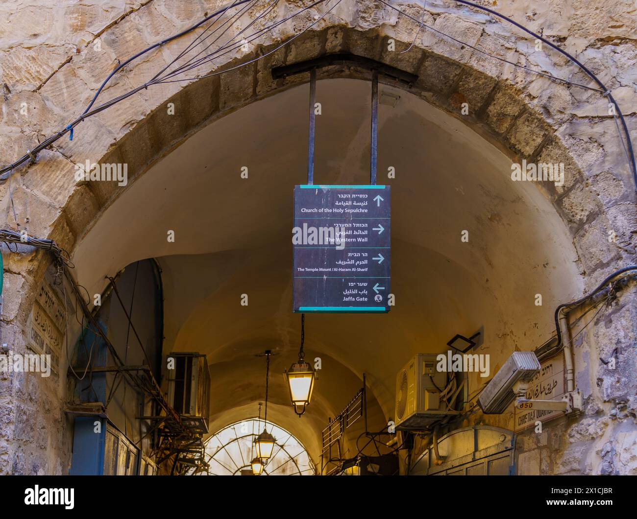 Jerusalem, Israel - April 12, 2024: View of an alley with trilingual ...
