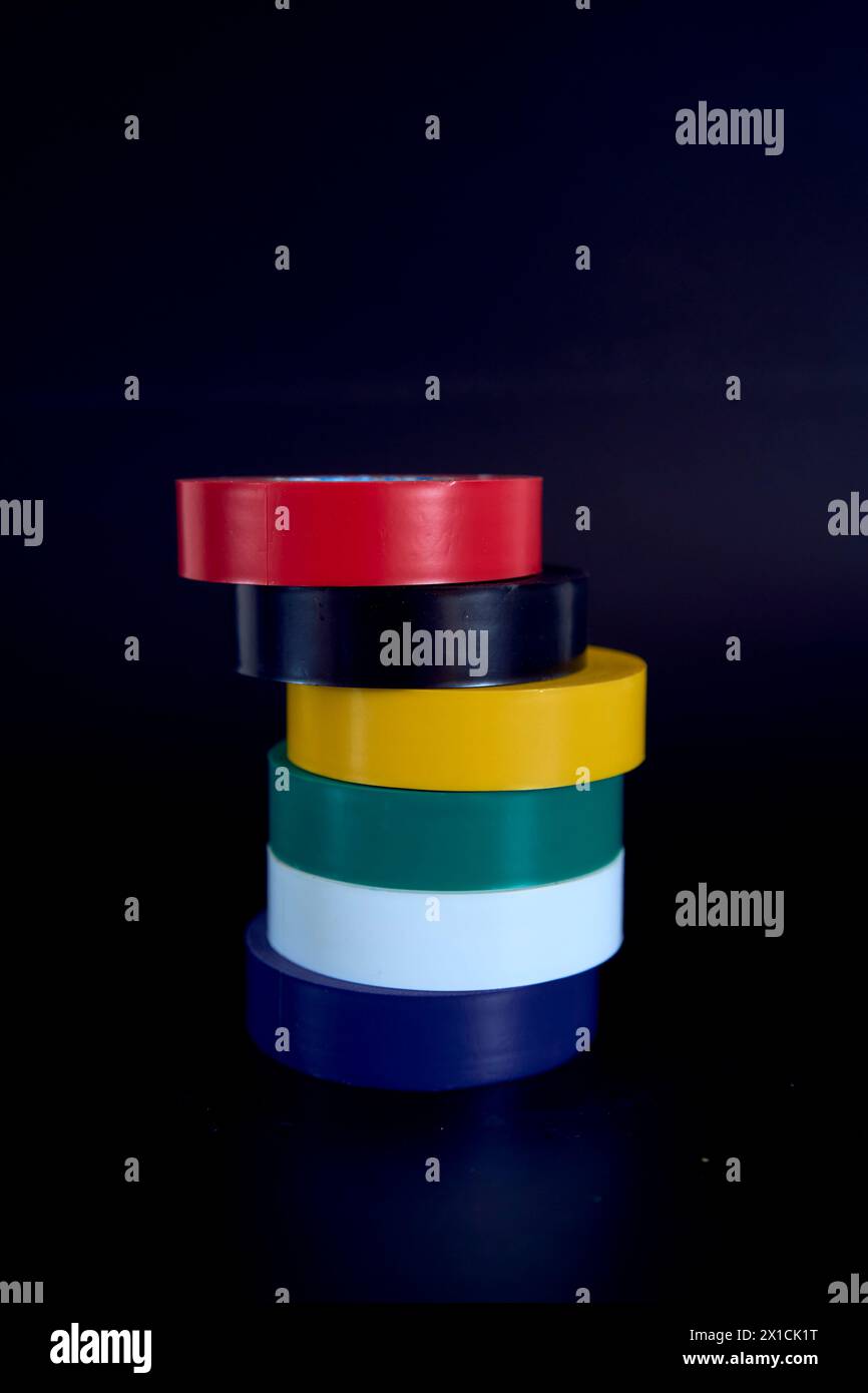 a set of colored insulating tape on a black background Stock Photo - Alamy