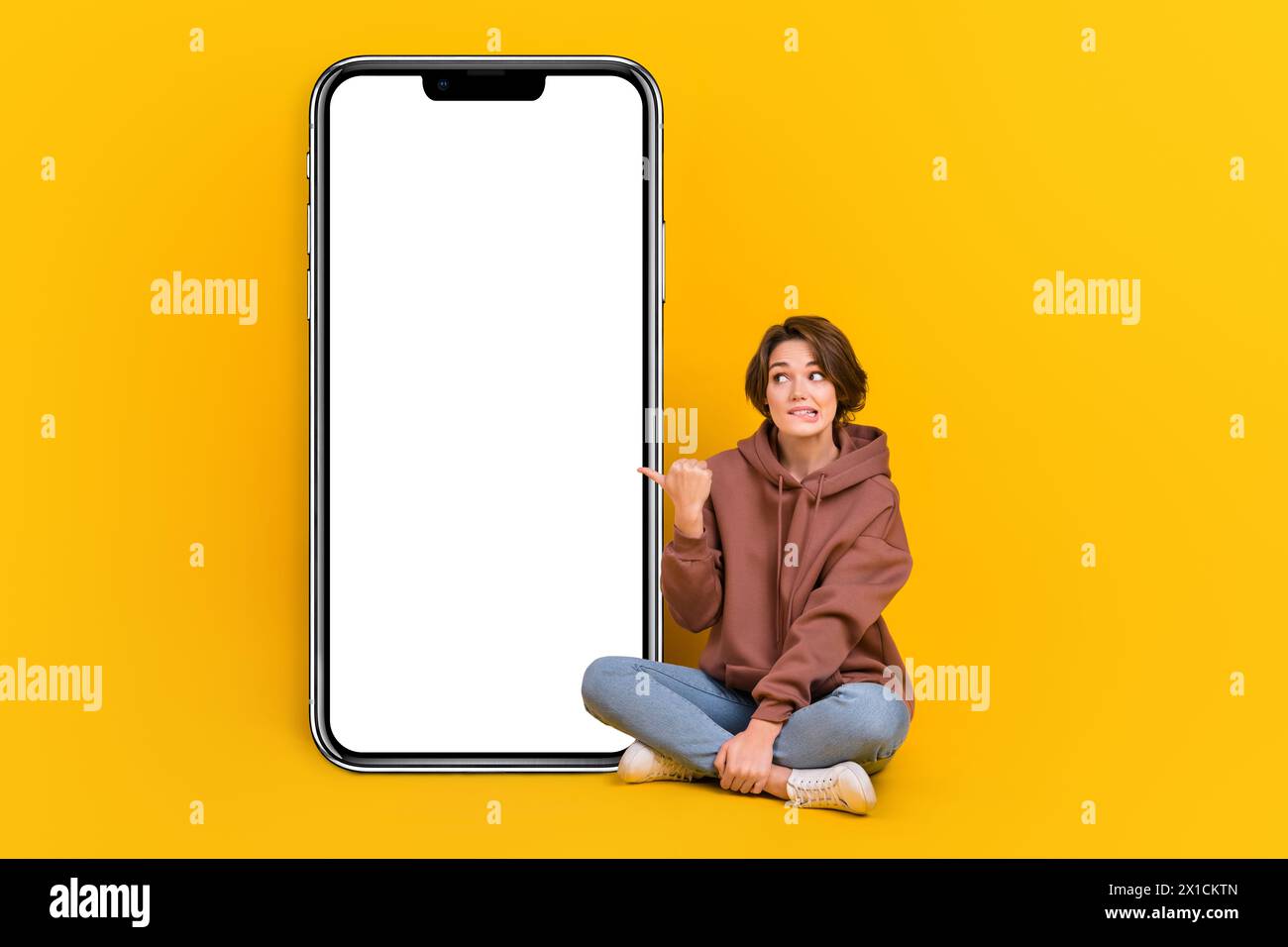 Full length portrait of nice person sit floor biting lips look indicate ...