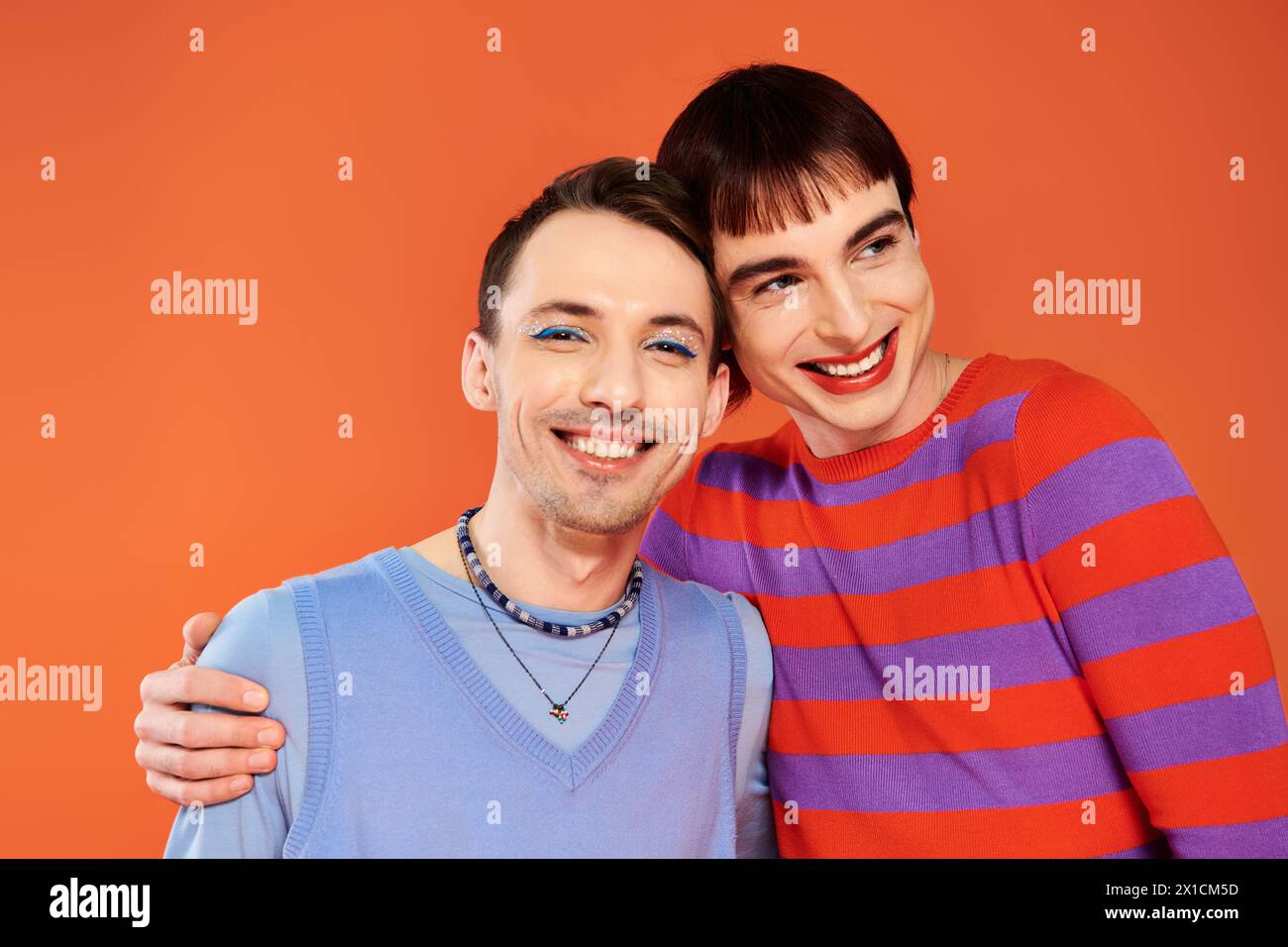 merry attractive gay friends with vivid makeup posing together on ...