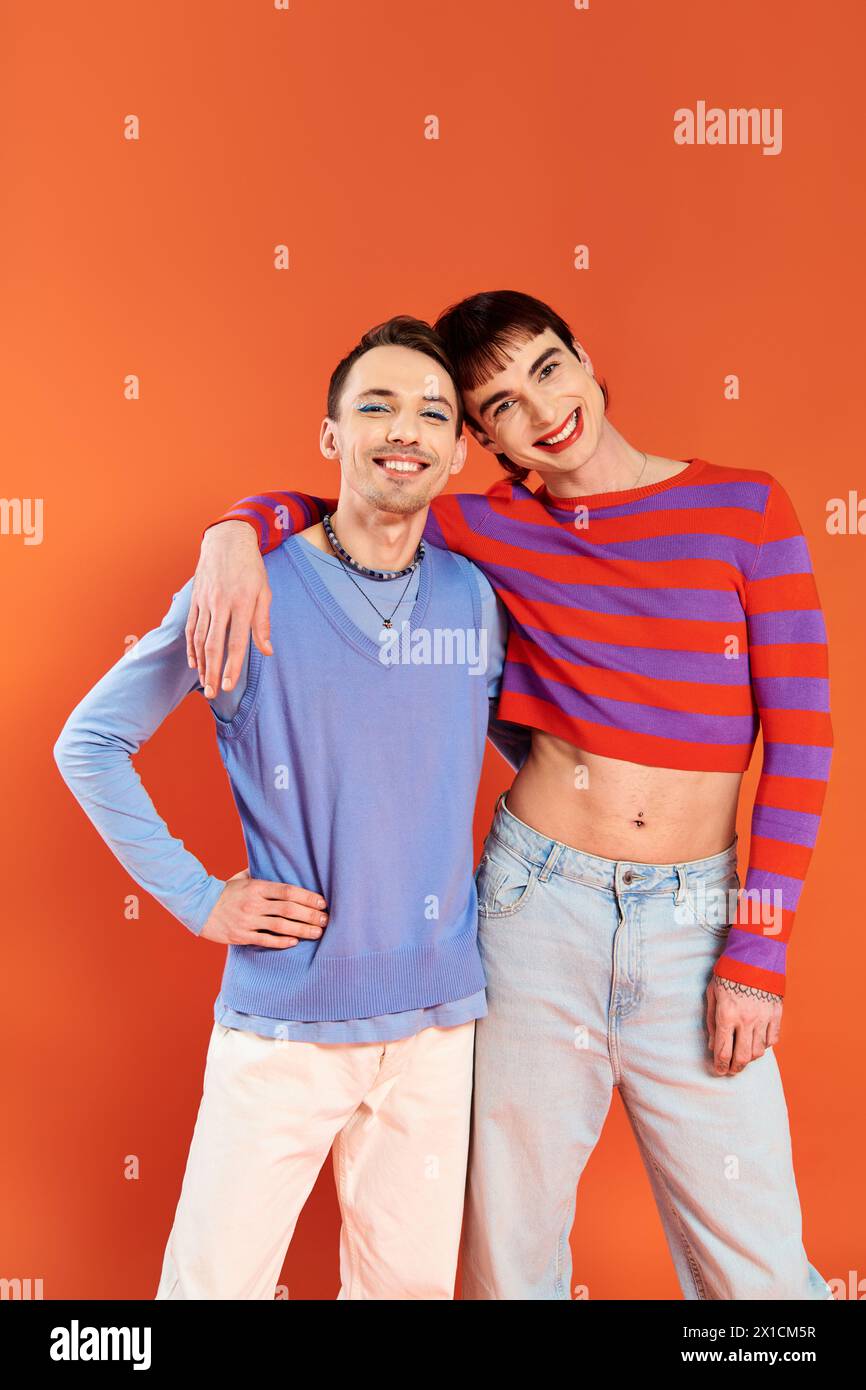 joyful attractive gay friends with vivid makeup posing together on ...