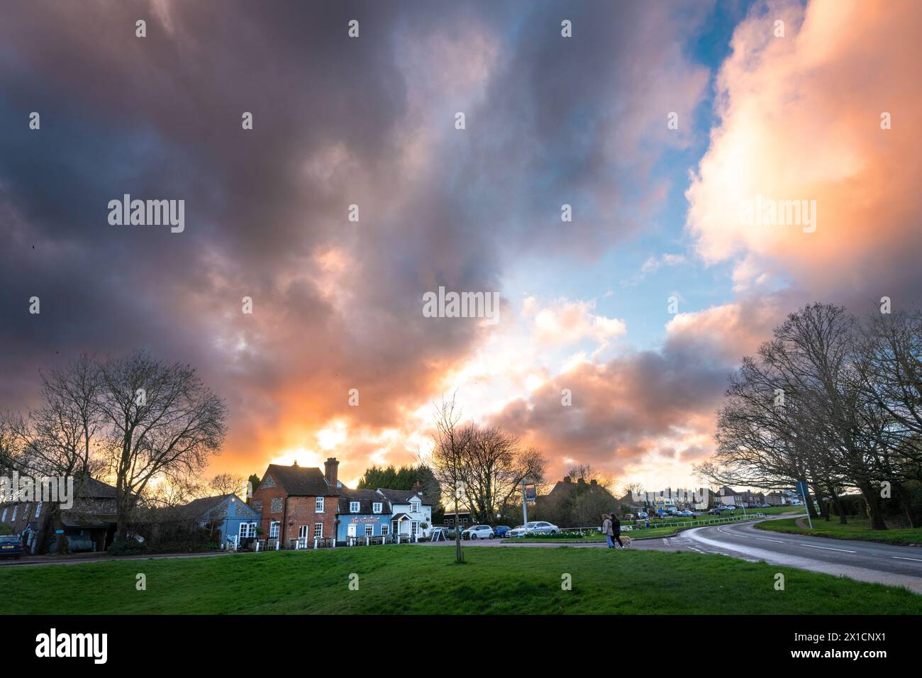 The Cricketers Pub, Sarratt, UK under a moody evening sky full of red ...